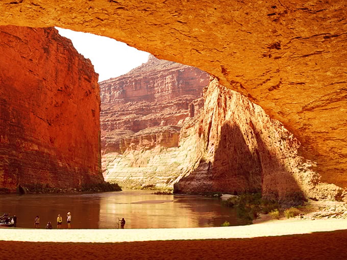 Golden hour transforms the canyon into a cathedral of light, with the Colorado River serving as nature's perfect reflecting pool.