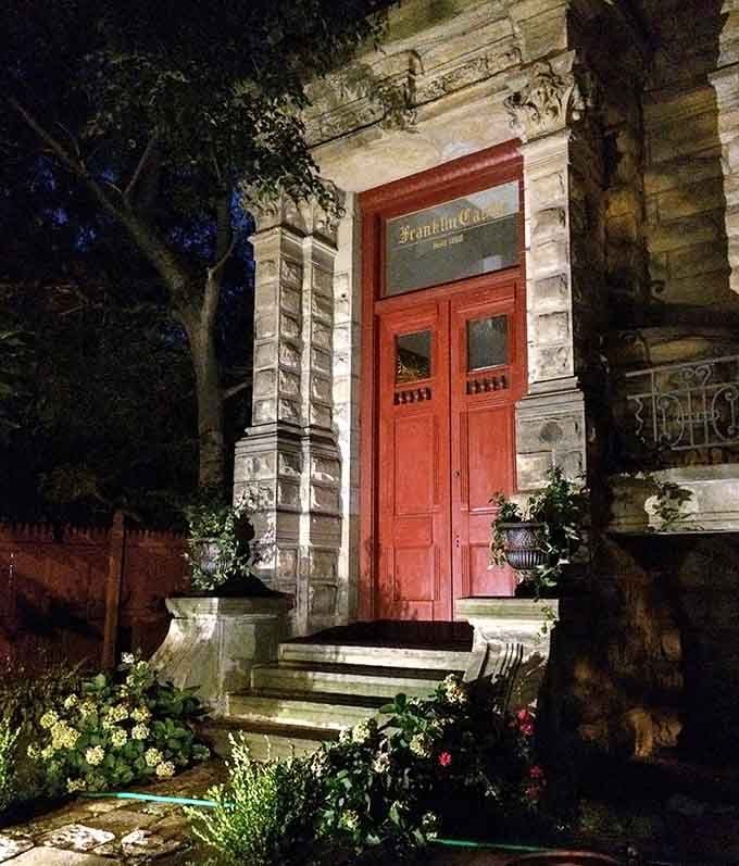 That red door beckons like a portal to another era, which is exactly what stepping through it feels like.