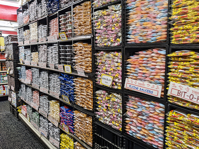 The wall of bagged candy creates a textile-like pattern of sweetness &ndash; a quilt of sugar where every patch promises different delights.