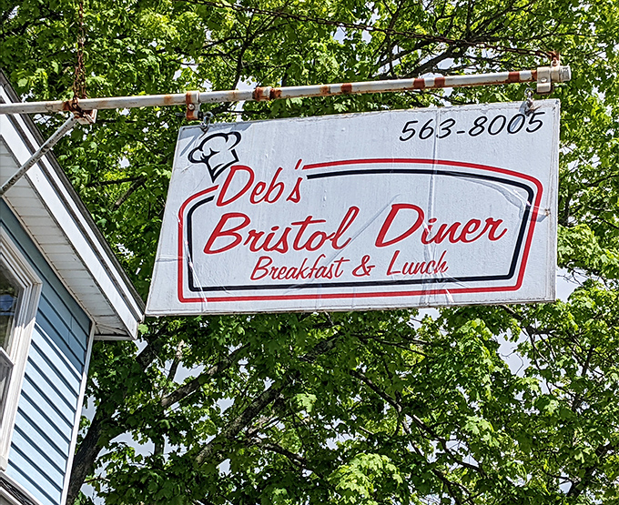 The sign hanging proud above Bristol Road, beckoning hungry travelers and dedicated regulars alike to experience breakfast done right at this beloved Maine institution.
