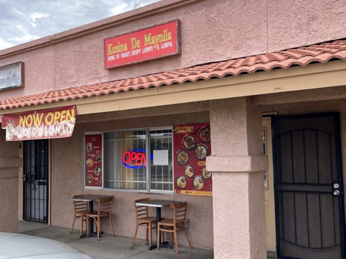 The iconic red sign that pork belly pilgrims look for. "Home of Pansit, Crispy Liempo & Lumpia" &ndash; a promise this kitchen delivers on with every order.