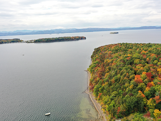 An aerial view reveals the perfect balance of forest and shoreline that makes Red Rocks a true Vermont treasure.