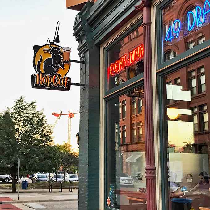 The illuminated "Events & Dining" sign glows invitingly against the green exterior, a beacon for hungry travelers as dusk settles over Grand Rapids.