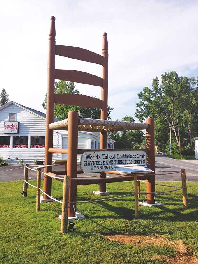 World's Tallest Ladderback Chair proclaims the sign proudly, giving Haynes & Kane Furniture their well-deserved credit. Some businesses build reputations; these folks built a landmark.