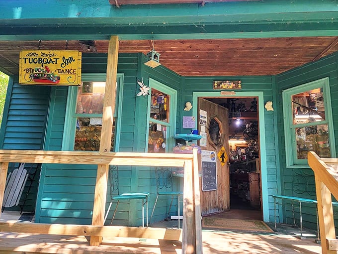 The turquoise charm of Beaver Island Toy Museum welcomes visitors with its playful porch and vintage sign promising nostalgic treasures inside.