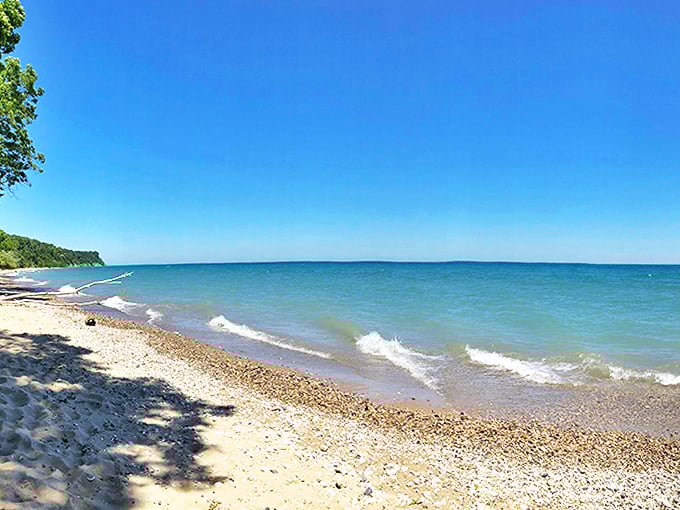 Pebbles and sand create a natural foot massage as you stroll along this hidden Lake Michigan gem.