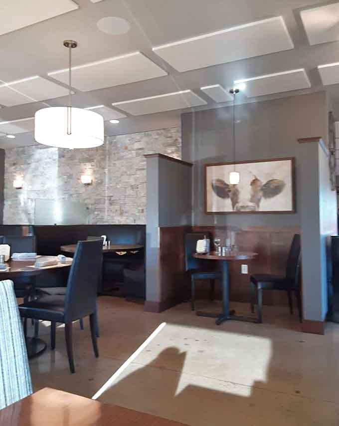 Modern comfort meets Midwest charm in a dining room where cow art feels perfectly at home and sophistication never gets stuffy.