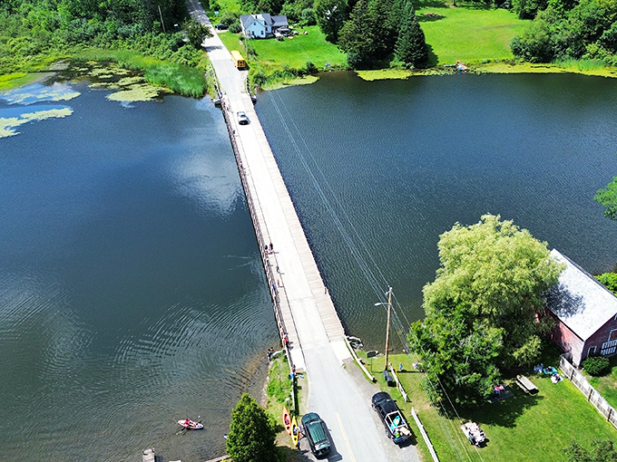 From above, the bridge appears as a thin line connecting shores, a man-made marvel nestled in nature's embrace.