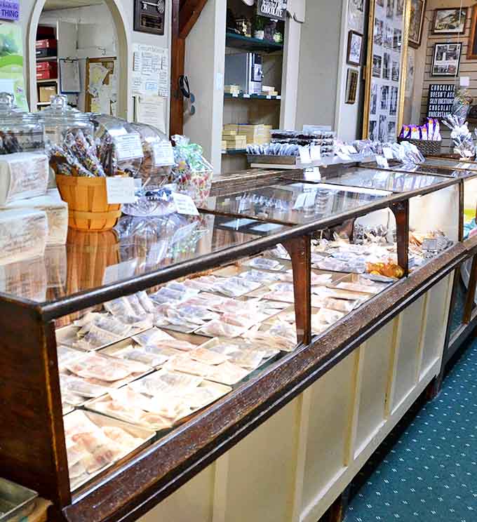 Interior: Glass cases gleaming with handcrafted treasures &ndash; this isn't just candy shopping, it's a pilgrimage for sweet tooth enthusiasts.