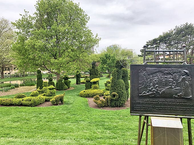 This bronze plaque tells the story behind the green figures, though the real magic happens when you step back and see the big picture.