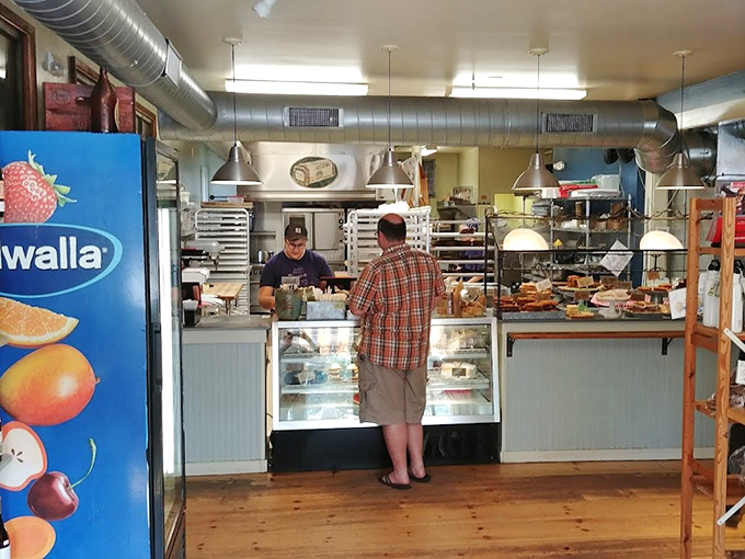 Behind the counter, baking magic happens as customers eye the day's offerings with the focused intensity of treasure hunters who've struck gold.