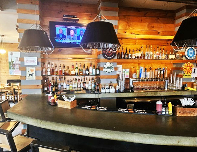 Warm wood paneling and industrial-chic lighting create the perfect backdrop for craft cocktails and casual conversation at Grazers' inviting bar.