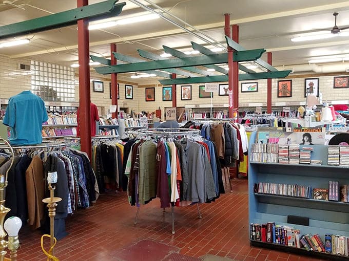 Those green beams frame a wonderland of secondhand splendor that's organized better than most people's actual closets at home.