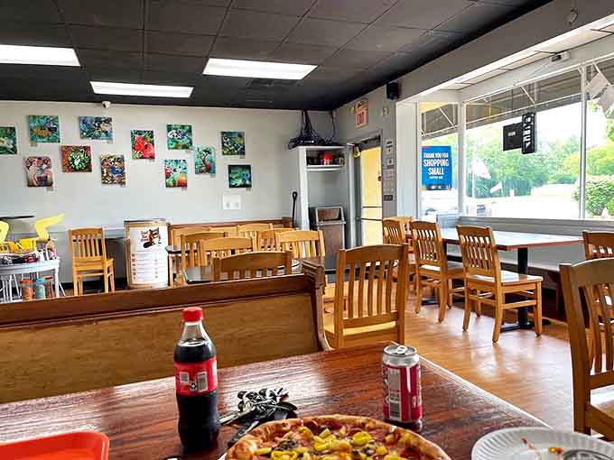 Simple wooden chairs and colorful local artwork create an unpretentious atmosphere where the food, not fancy decor, takes center stage.