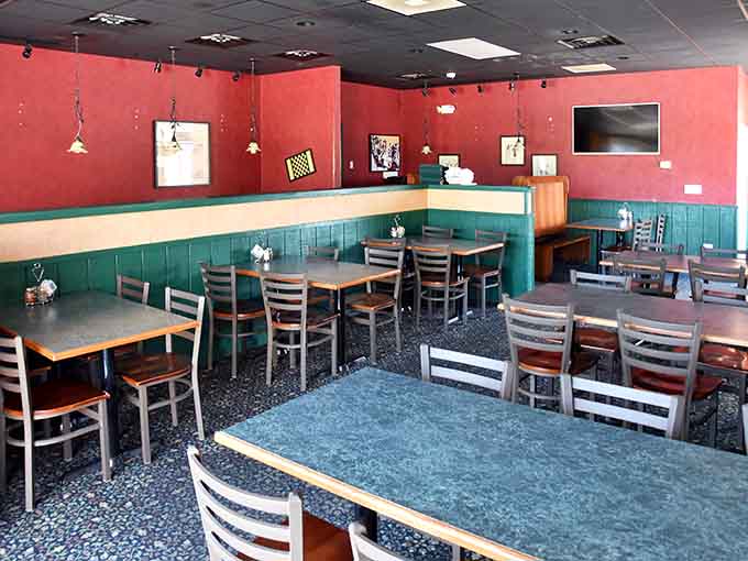 The welcoming interior features warm red walls and comfortable seating where countless pizza lovers have created delicious memories over the years.