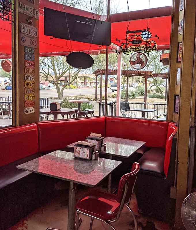 Red vinyl booths and retro memorabilia create the perfect backdrop for serious burger consumption and casual conversation.