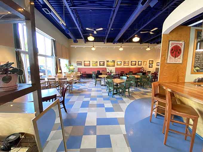 Those blue and white checkerboard floors and mismatched chairs create the kind of welcoming vibe that makes you want to settle in for hours.