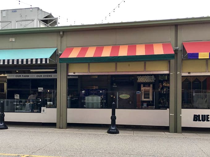 The colorful awnings and bustling crowds signal you've arrived at Blue Oven Bakery, where Cincinnati's best English muffins await inside.
