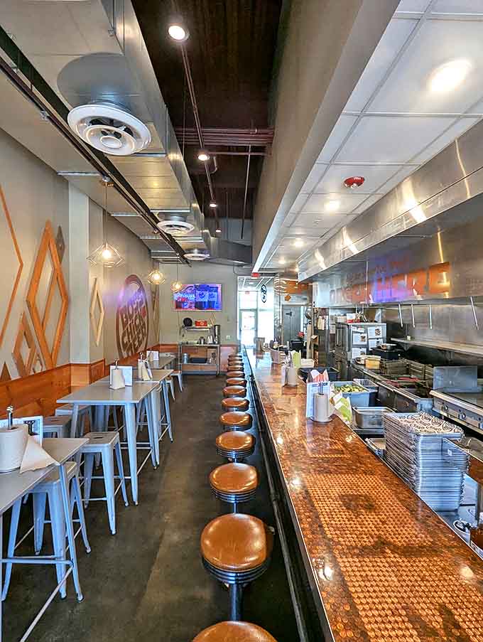 Penny-topped counters gleam under pendant lights while wooden stools invite you to pull up and stay awhile in this industrial-cozy chicken haven.