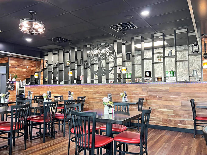 Modern meets cozy in this thoughtfully designed interior, where wood accents and red cushions create the perfect backdrop for memorable meals.