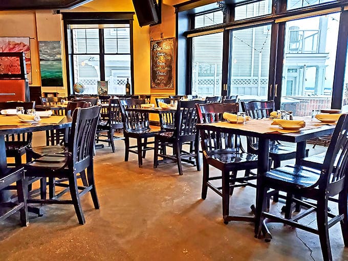 Warm yellow walls and dark wood furniture create an atmosphere that's both sophisticated and inviting&mdash;perfect for lingering conversations.