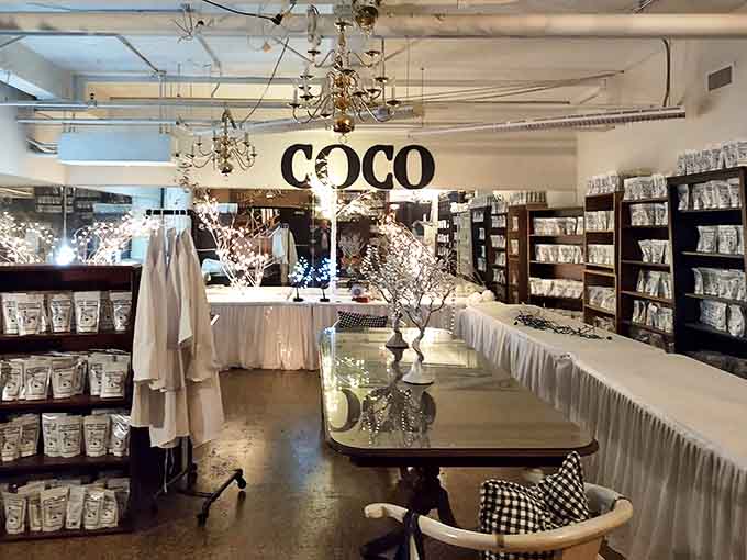 The pristine "Coco Room" where elegance reigns supreme &ndash; crystal chandeliers illuminate white displays in this sanctuary of sophisticated style.