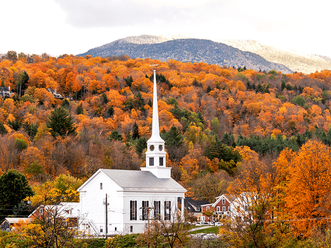 The classic white steeple of Stowe Community Church stands sentinel against a backdrop of fiery foliage&mdash;New England perfection.