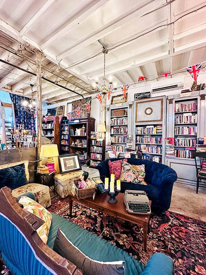 Interior: Step into a literary haven where blue velvet meets vintage charm. The British flags overhead add just the right touch of international flair.
