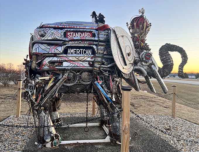 From this angle, the elephant's intricate construction reveals itself, each piece of scrap metal contributing to something magnificently absurd.