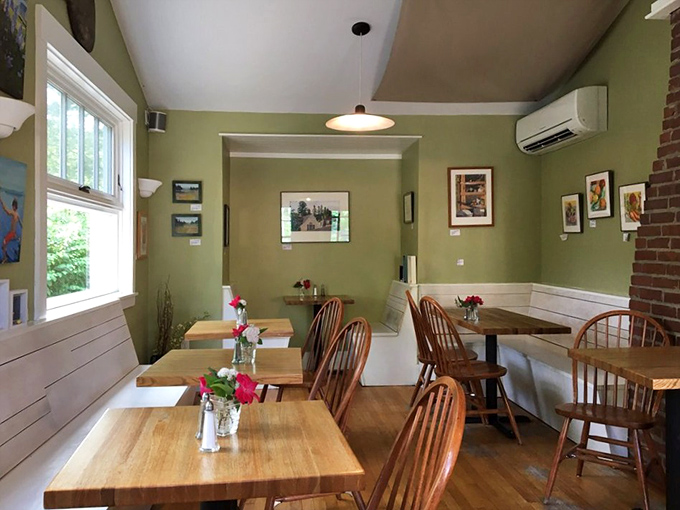 Cozy green walls and Windsor chairs create the perfect backdrop for carb-induced euphoria in this welcoming dining area.