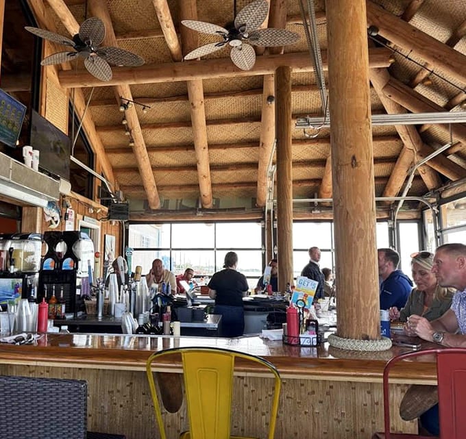Those log beams and woven ceiling fans create a tropical treehouse vibe that makes you forget you're in Ohio.