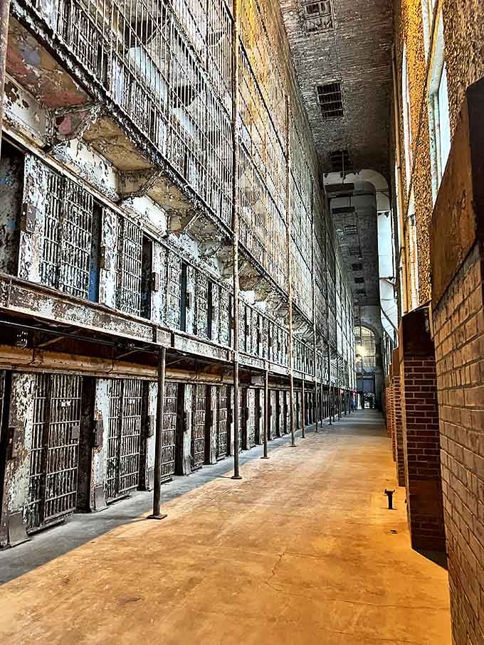 East Block: Six tiers of steel cells stacked like a human filing cabinet, where sunlight filters through as a cruel reminder of freedom.