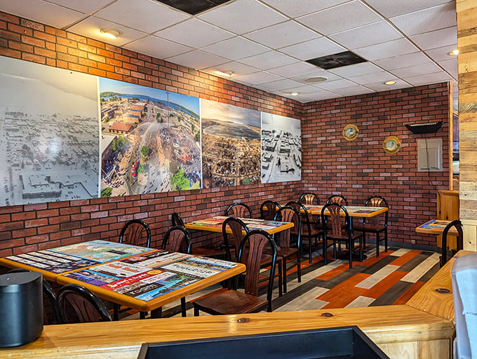 Inside, exposed brick walls adorned with stunning UP photography create a warm atmosphere, while colorful floor planks add playful charm.