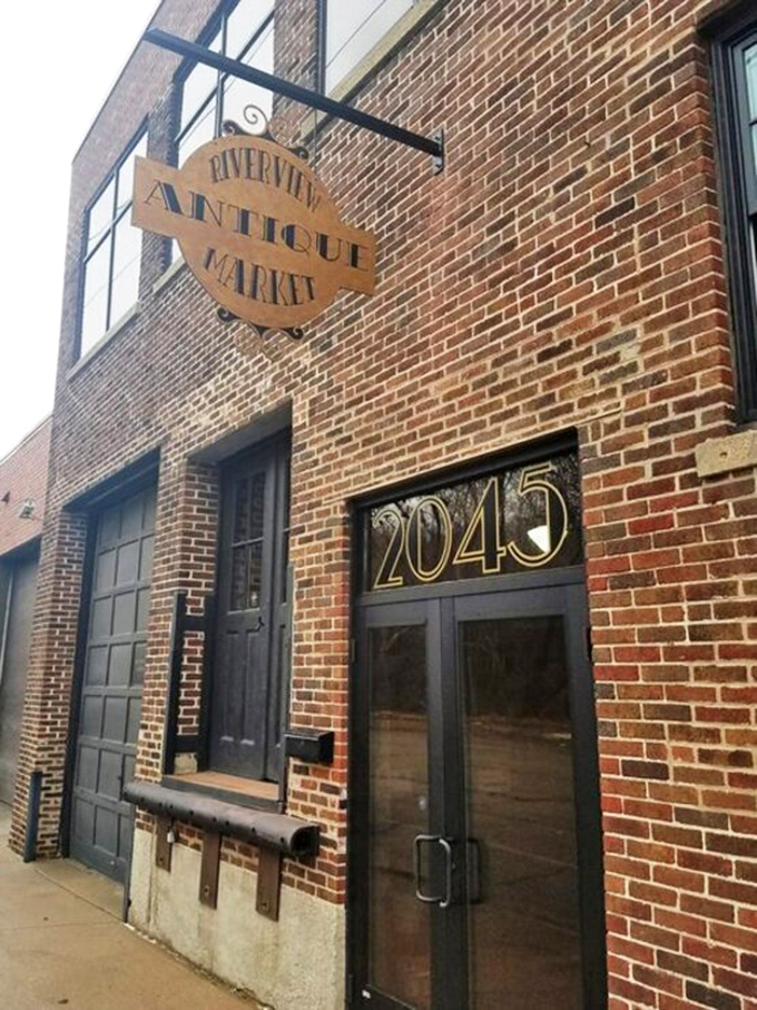 A brick-and-mortar time machine! Riverview Antique Market's facade promises adventures in every window, with history peeking out from behind the glass.