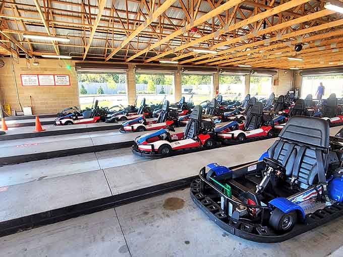 The starting line at Funway's go-kart facility showcases their impressive fleet of red, white, and blue speed machines.