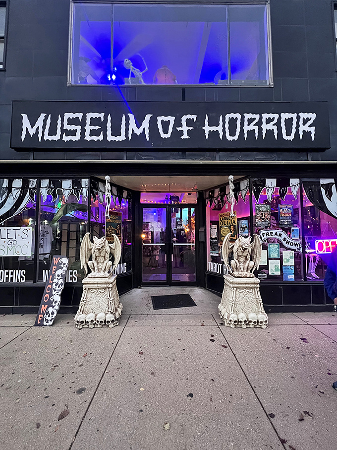 Gargoyle sentinels flank the entrance, their stone eyes seemingly following visitors as they approach the museum's haunted threshold.