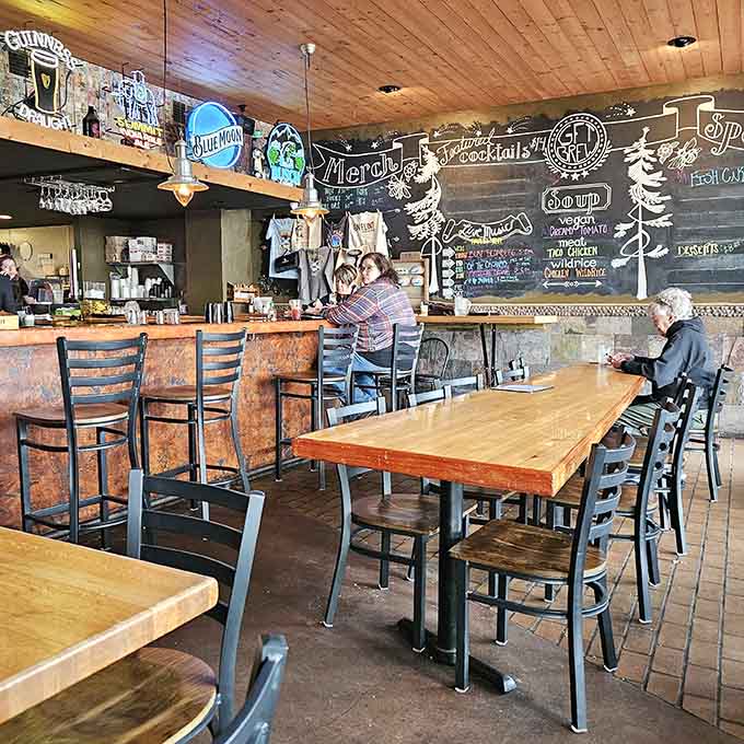 Warm wood tones and thoughtful lighting create an inviting atmosphere where strangers become friends over exceptional food and cold drinks.