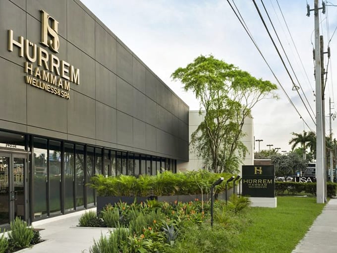 Front View: Lush greenery frames the entrance, creating a transition zone where Wisconsin ends and Ottoman luxury begins.