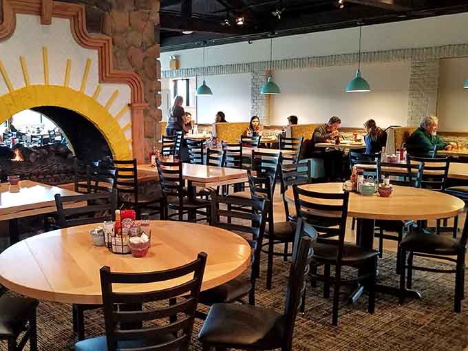 Sunlit dining room with cheerful yellow archway creates the perfect backdrop for breakfast magic.