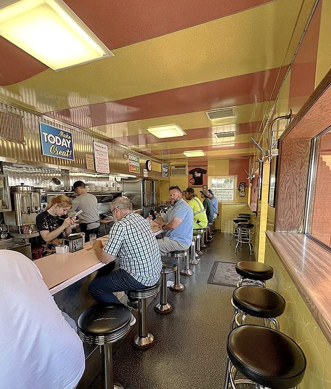 Counter seating and corrugated metal walls create the perfect retro atmosphere where strangers become temporary breakfast companions.