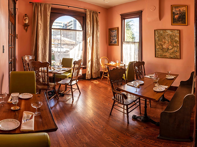 Grandma's living room meets hipster chic in this cozy dining space. Warm peachy walls, eclectic artwork, and mismatched chairs create an atmosphere that's equal parts nostalgic and Instagram-worthy.
