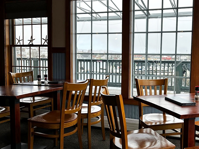 Starfish decorations and harbor views transform simple wooden tables into front-row seats for nature's daily maritime show.
