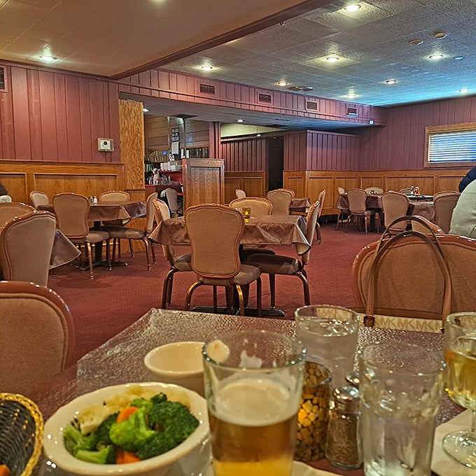 Classic supper club ambiance with wood-paneled walls and comfortable seating &ndash; where conversations flow as smoothly as the cocktails.