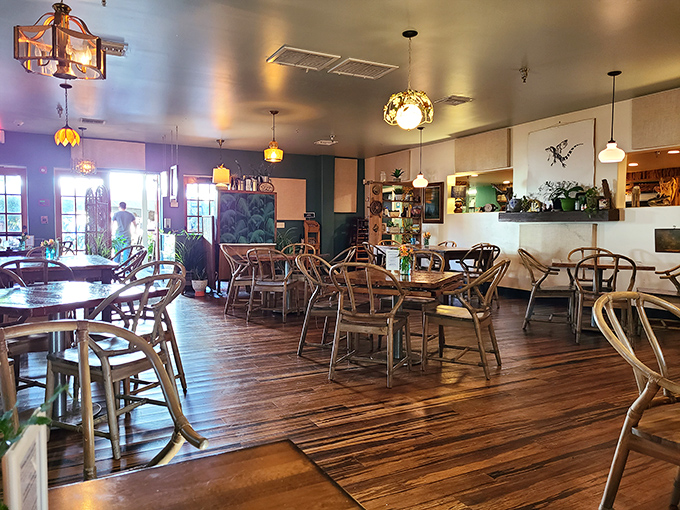 Interior: Warm wooden floors meet eclectic lighting in this inviting space where every meal feels like coming home.