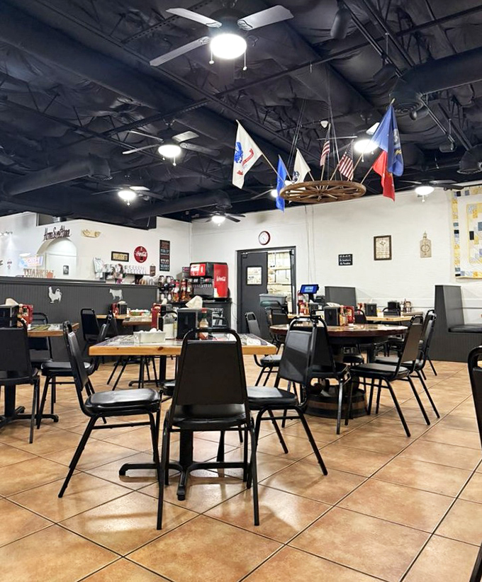 Inside, the cozy dining room balances nostalgic diner aesthetics with warm hospitality, flags proudly displayed above tables ready for hungry patrons.