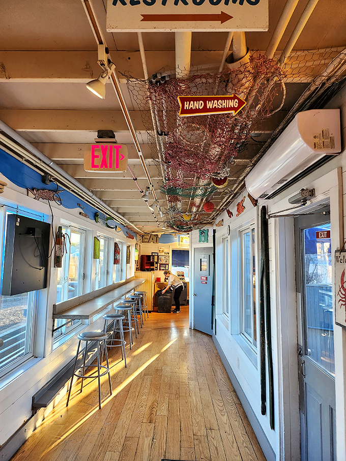 Fishing nets adorn the ceiling of this narrow corridor, where hungry patrons line up for their seafood fix with joyful anticipation.
