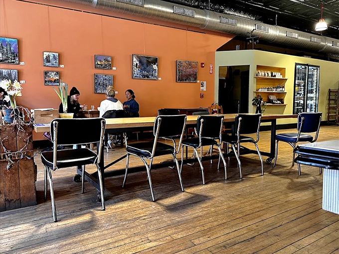 Warm orange walls and a communal wooden table create the perfect backdrop for bagel-fueled conversations and coffee revelations.
