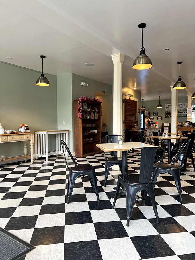 Black and white checkered floors play against soft green walls, creating a space where vintage charm meets modern comfort. The kind of place where calories don't count.
