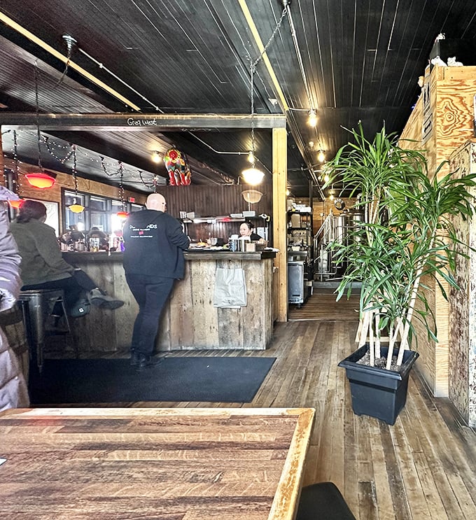 Rustic meets refined at the bar, where weathered wood and warm lighting create the perfect backdrop for serious food contemplation and lively conversation.