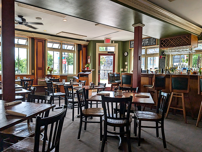 Warm wood tones and green walls create a cozy atmosphere where conversations flow as freely as the coffee refills.